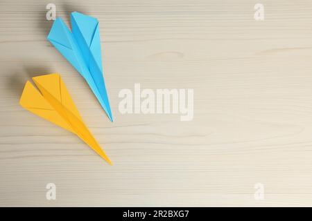 Blue paper planes on beige background Stock Photo - Alamy