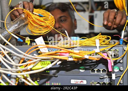 A telecom engineer checks the network link at the transmission room of ...
