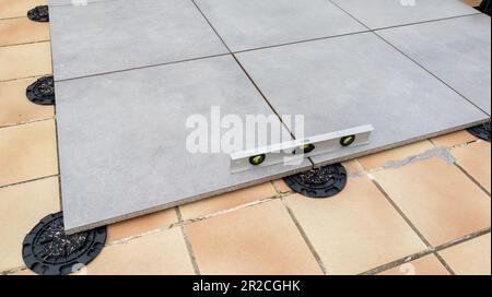 Exterior pavement tiles installation for house terrace with adjustable ...