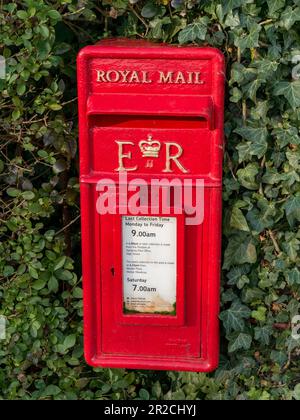 Freshly painted bright red Royal Mail post box with gold lettering ...