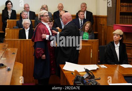 Sheriff Principal Craig Turnbull is given his robes as he is installed ...