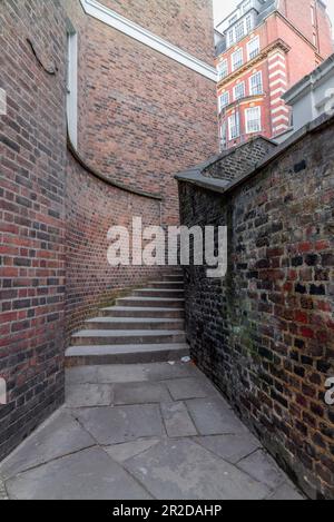 A mysterious and hidden old back alley with staircase in London at ...