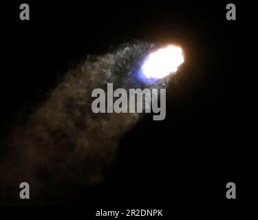A contrail from a SpaceX Falcon 9 rocket launch is seen over homes ...