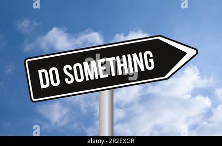 Do something road sign on cloudy sky background Stock Photo - Alamy