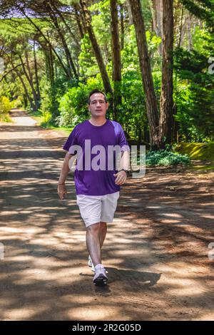 Male athlete walking after running outdoors Stock Photo - Alamy