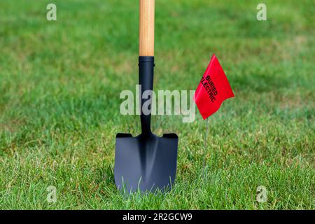 A Buried Electric Line marking flag in the grass marking the location ...