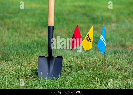A Buried Electric Line marking flag in the grass marking the location ...