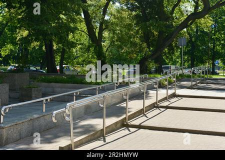 Outdoor stairs with ramp and metal railings Stock Photo - Alamy