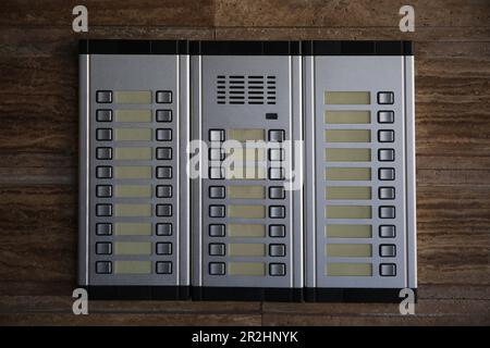 Modern intercom system on stone wall, space for text. House security ...