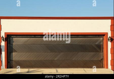Garage building with closed sectional metal gate Stock Photo - Alamy