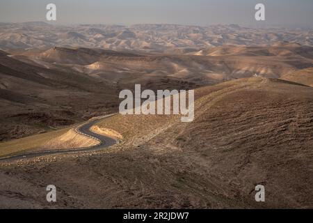 well-developed road leads through barren landscape to the fortress of ...