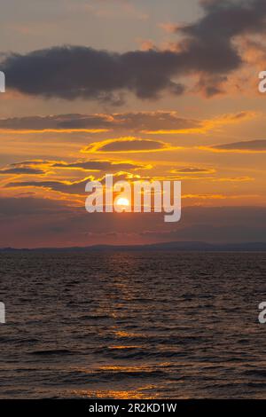 The setting sun lighting up the horizon Stock Photo - Alamy