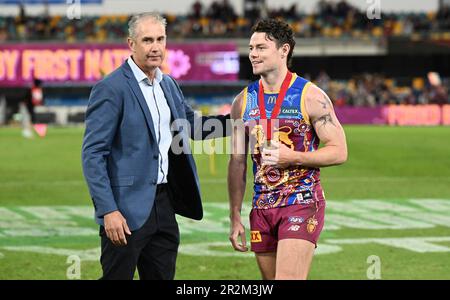 Lachie Neale (right) of the Lions is presented with the Marcus Ashcroft ...