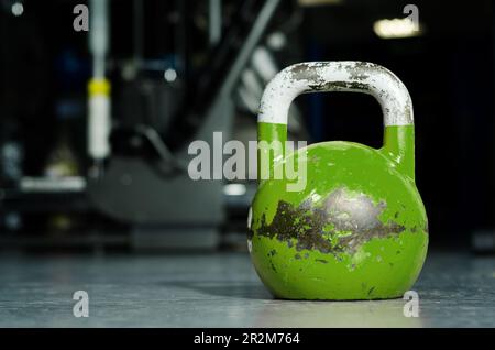 Old used red kettlebell on the gym floor ready for crossfit strength ...