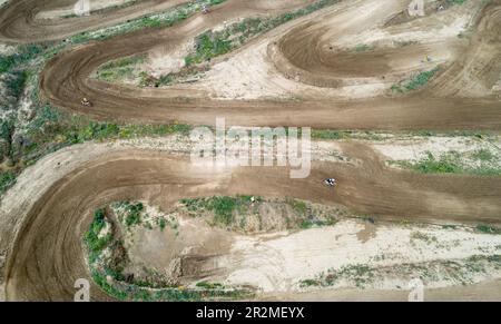 Drone view of bikers riding motorcycles along empty roadway in ...