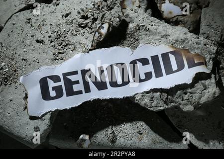 Paper with word Genocide on pieces of concrete, top view Stock Photo ...