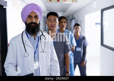 Portrait of diverse male and female doctors standing in hospital ...