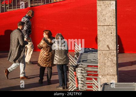 people passing a red grandstand set up for the carnival processions in ...