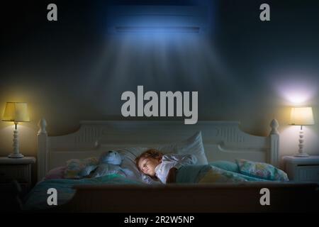 Air conditioner in bedroom. Kids room climate control. Mother and child ...