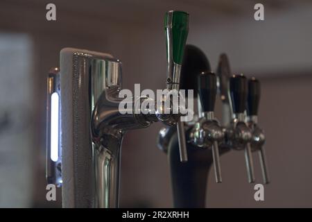Row of lager and beer taps on a pub bar, Peroni, Amstel, Korev ...
