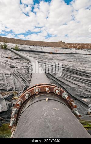 Detail shot of a bolted flange joining large pipes that carry methane ...