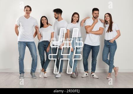 Hashtag icon and group of happy people on white background Stock Photo ...