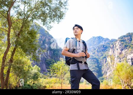 Young Chinese man hiking outdoors Stock Photo - Alamy