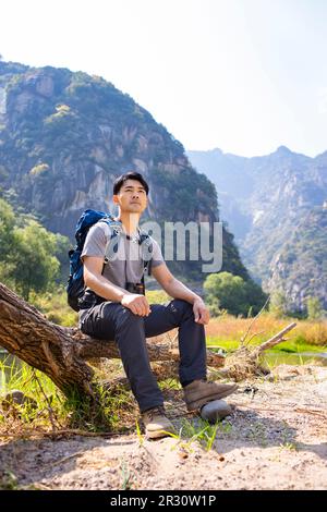 Young Chinese man hiking outdoors Stock Photo - Alamy
