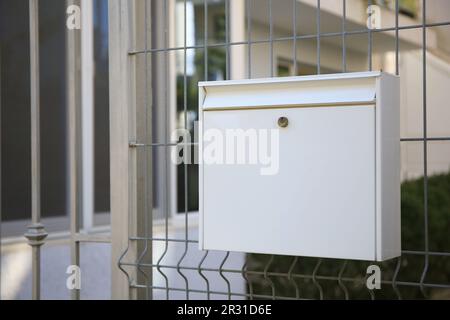 White metal letter box on fence outdoors Stock Photo - Alamy