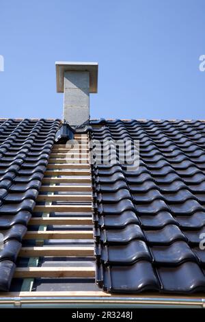 stack of black roof tiles on the roof battens Stock Photo - Alamy