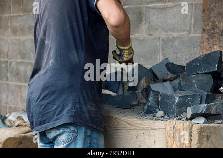 a stonemason working with stone, craft for construction and ...