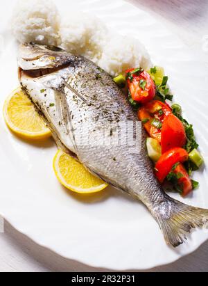 Baked Dorado fish served lemon slice Stock Photo - Alamy