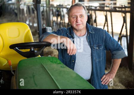 Male farm owner on tractor Stock Photo - Alamy