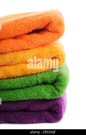Stack folded purple, yellow, green baby cotton clothing on white ...