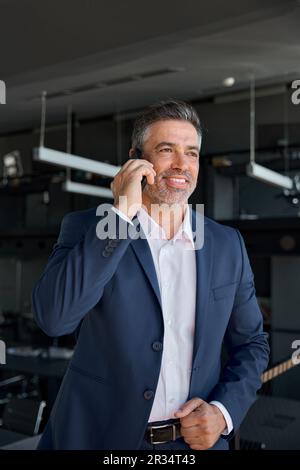 Company leader talking on cell phone. Surprised businessman talking on ...