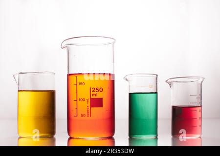 Laboratory beakers filled with green color liquid substances Stock ...