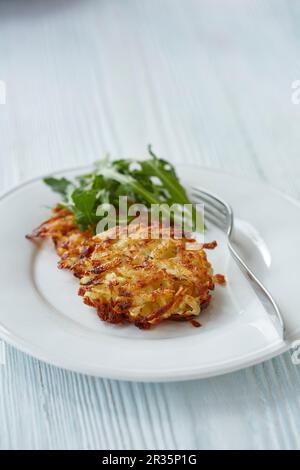 A potato fritter with rocket Stock Photo - Alamy