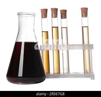Different laboratory glassware with brown liquids on white background ...