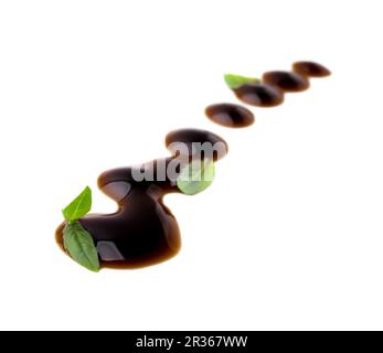 Balsamic glaze and basil leaves on white background Stock Photo - Alamy