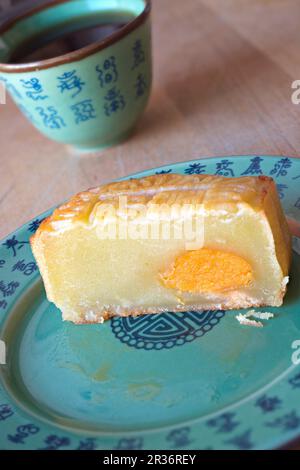 Close up of cut Chinese mooncake wedge with lotus seed paste and salted ...