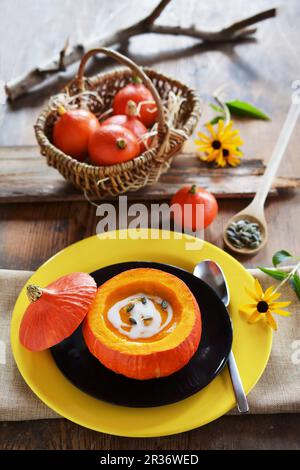 Pumpkin soup served in the hollowed out hokkaido pumpkin Stock Photo ...