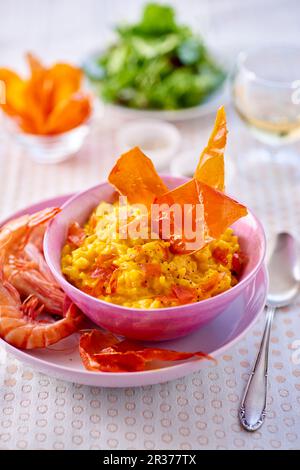 Saffron risotto with prawns and ham Stock Photo - Alamy