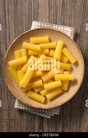 rigatoni type pasta on a wooden pastry board with flour Stock Photo - Alamy