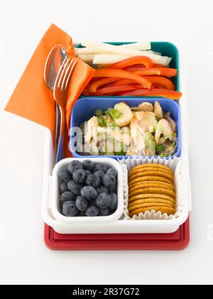 Healthy packed lunch box containing brown cheese roll, apple, banana ...