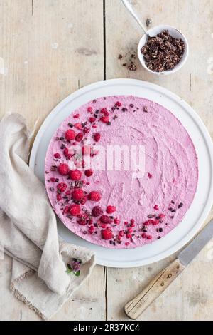 Top view shot of a raw cheesecake in a glass bowl on a purple towel ...