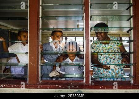 School boy cleaning the windows of their school, Yanuya island ...