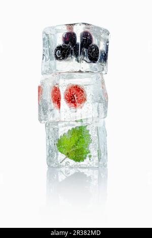 Three ice cubes with melissa Stock Photo - Alamy