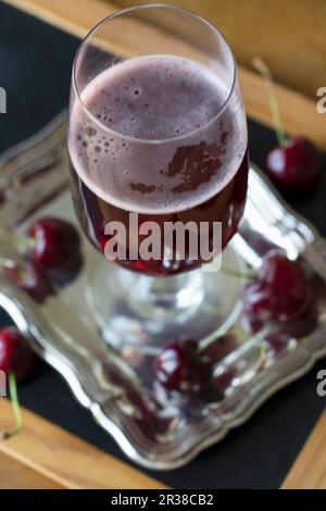 Beer with cherry inside Stock Photo - Alamy