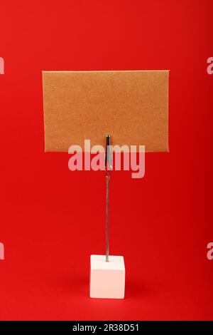 Blank brown kraft paper sign over red background Stock Photo - Alamy