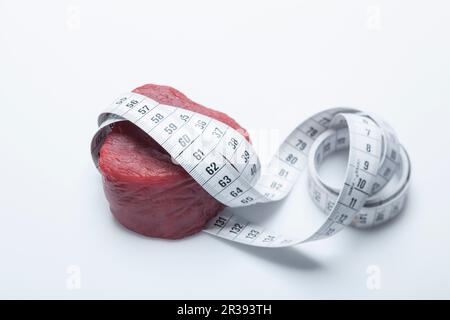A raw fillet of beef with a tape measure Stock Photo - Alamy